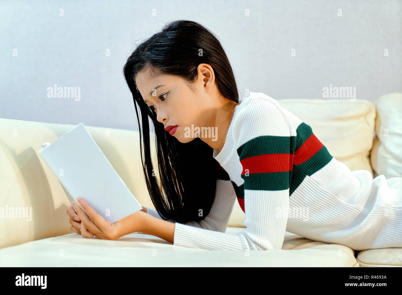 Beautiful women posing - reading a book, serious woman Stock Photo - Alamy