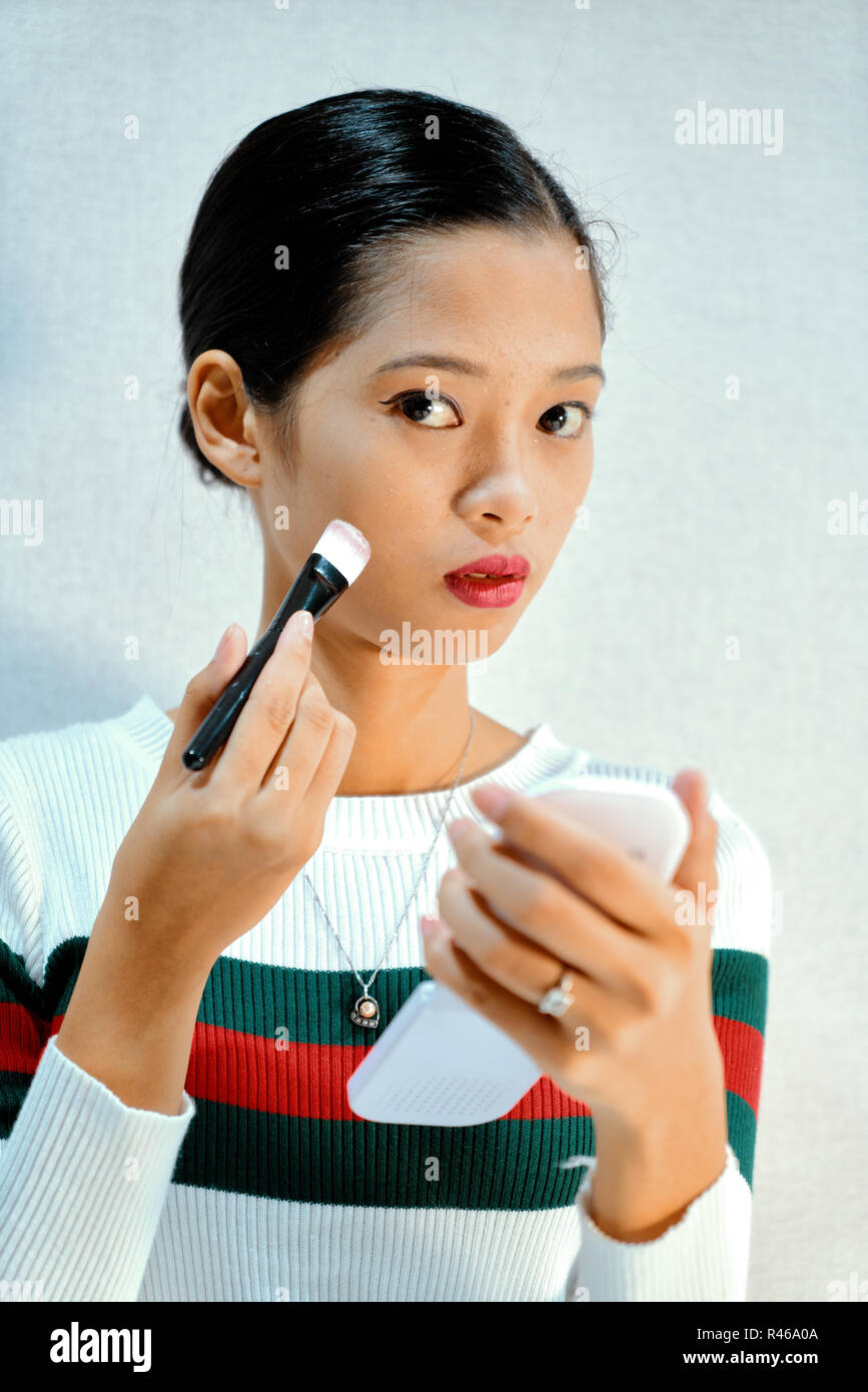 Beautiful women posing - applying makeup Stock Photo - Alamy