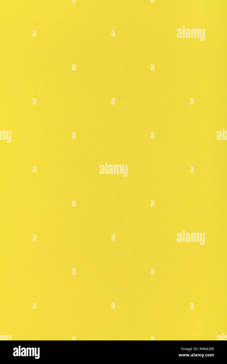 yellow color toned vertical sheet of paper Stock Photo - Alamy