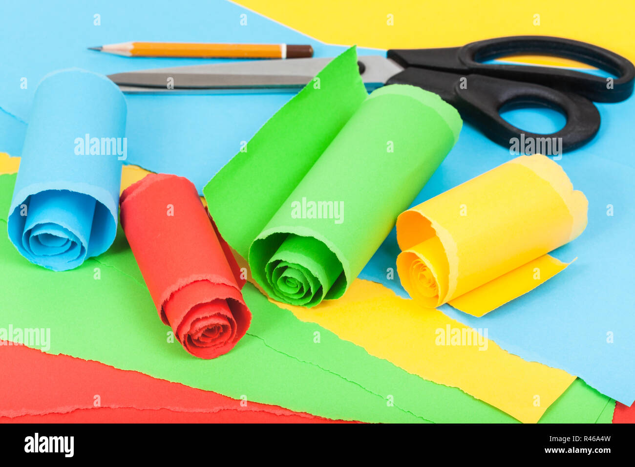 scissor, pencil and rolled color paper Stock Photo - Alamy