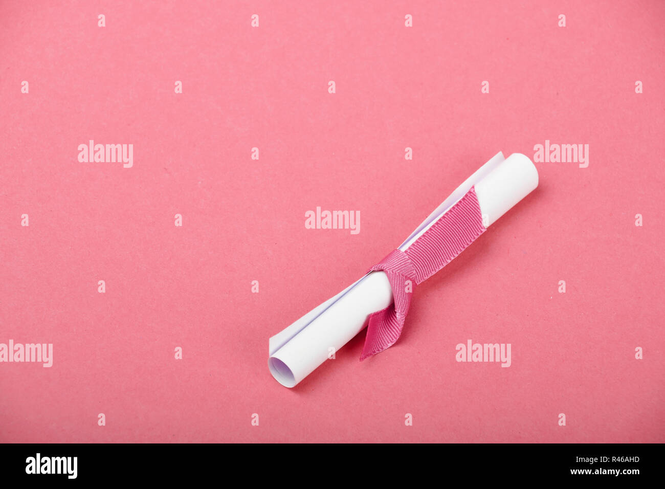 One white paper scroll message on pink background Stock Photo - Alamy