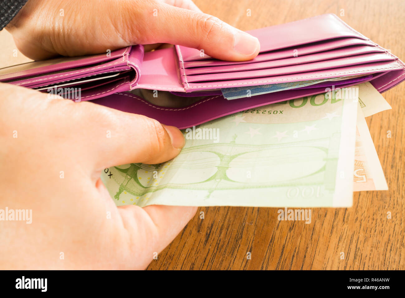Hand on international currencies bank note in the wallet Stock Photo ...