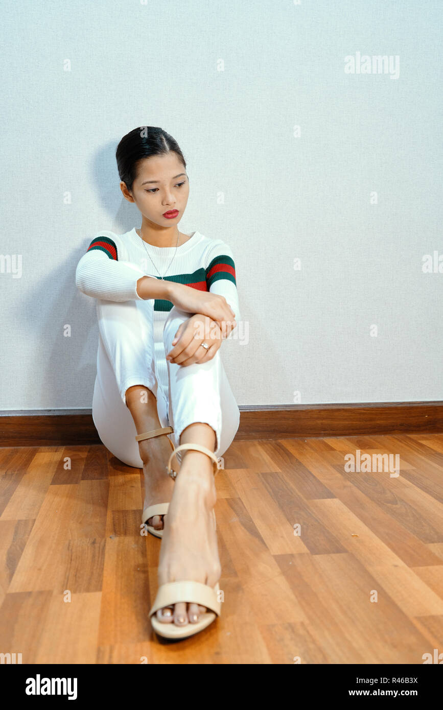 Beautiful woman posing - looking down and sad Stock Photo - Alamy