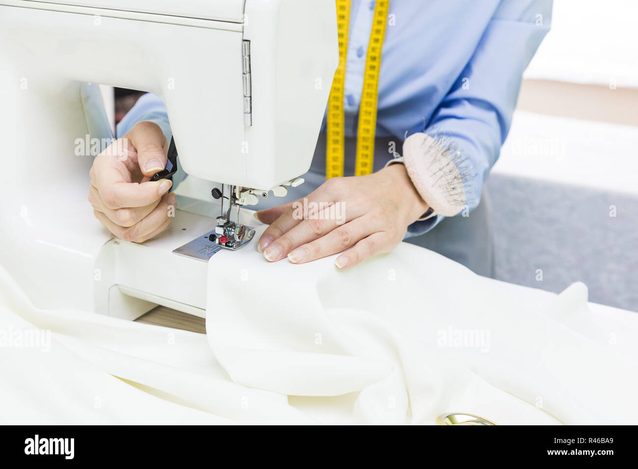 Sewing workshop. Seamstress at work. Young woman working with sewing ...