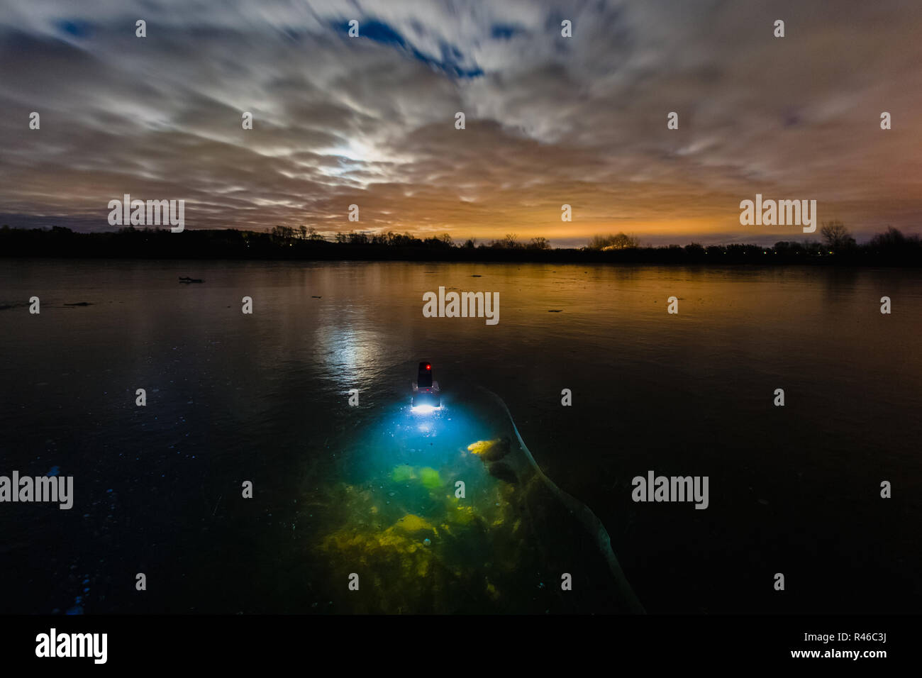 Still life with underwater plant under surface of frozen lake Stock ...