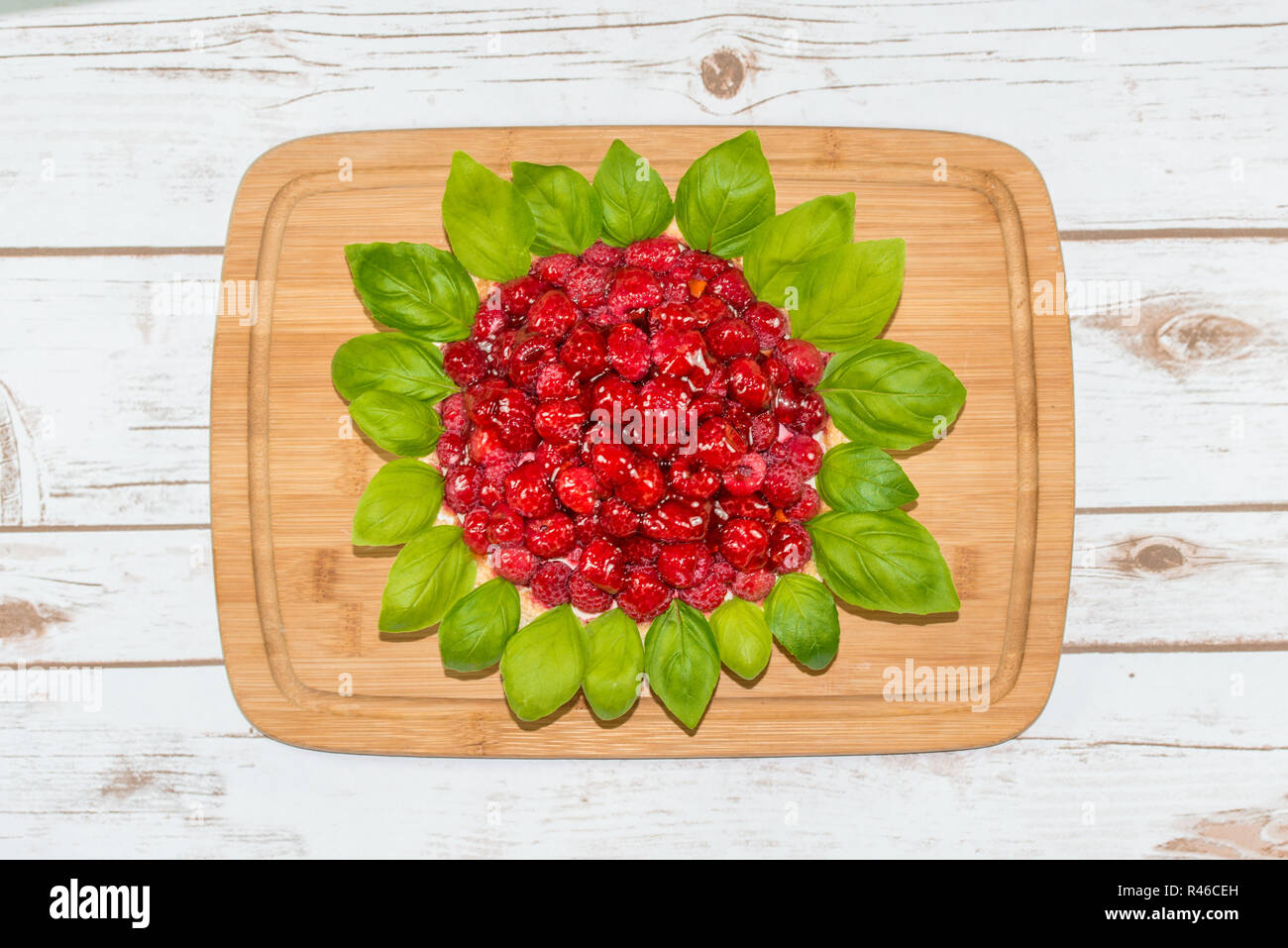 Raspberry cake decorated with basil leaves Stock Photo - Alamy