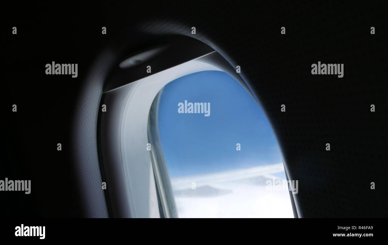 Airplane window with blue sky Stock Photo - Alamy