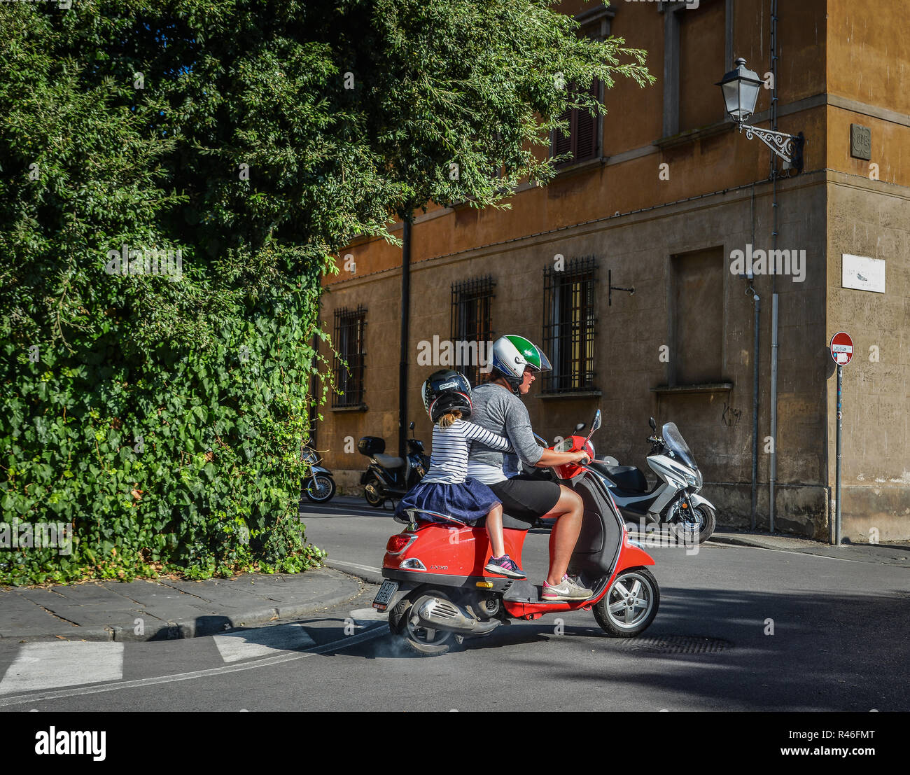 Pisa, Italy - Oct 18, 2018. People riding Vespa on street in Pisa ...