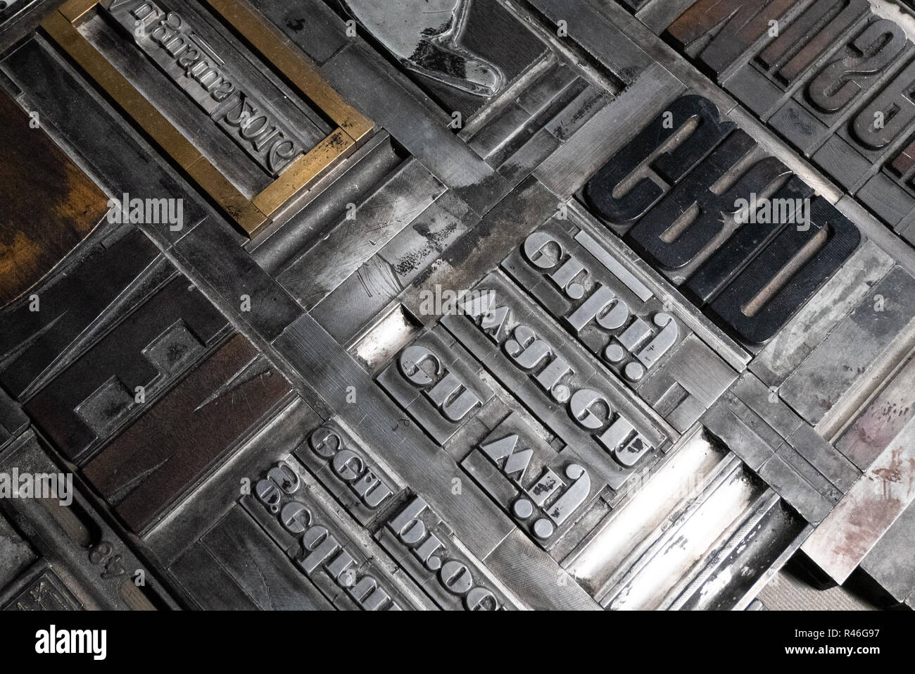 Close up of inverted metal type letters for setting on an old ...