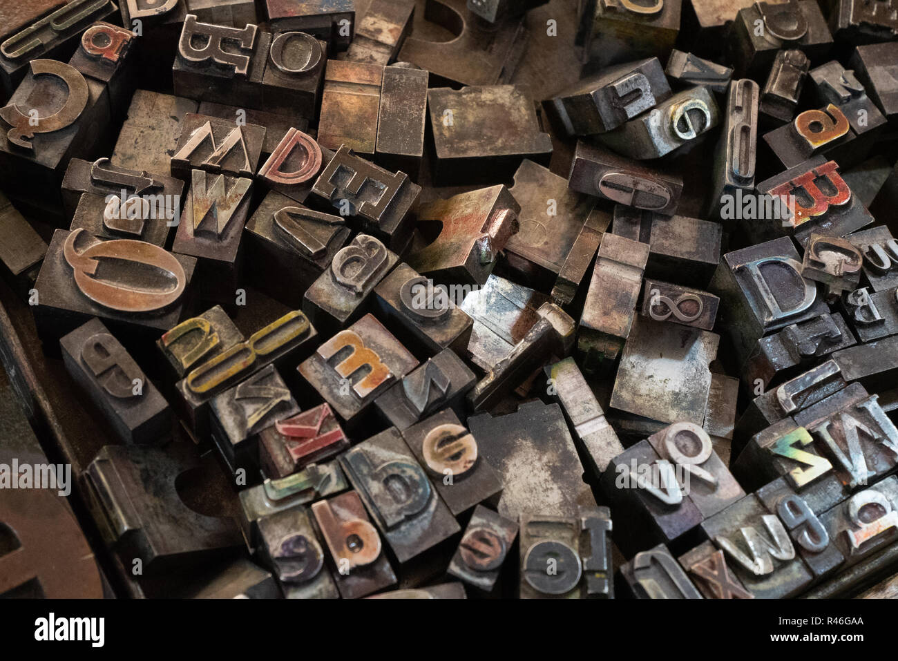 Jumble of different metal letters in a tray for use in an old ...