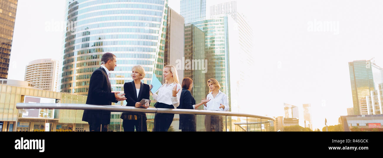 Happy business team members talking outside in Stock Photo - Alamy