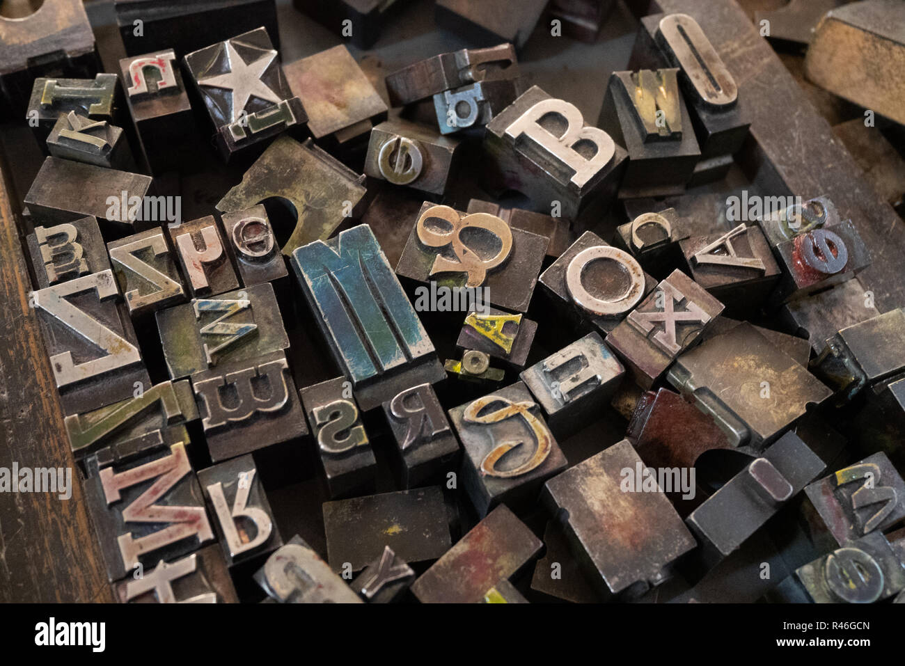 Jumble of different metal letters in a tray for use in an old ...