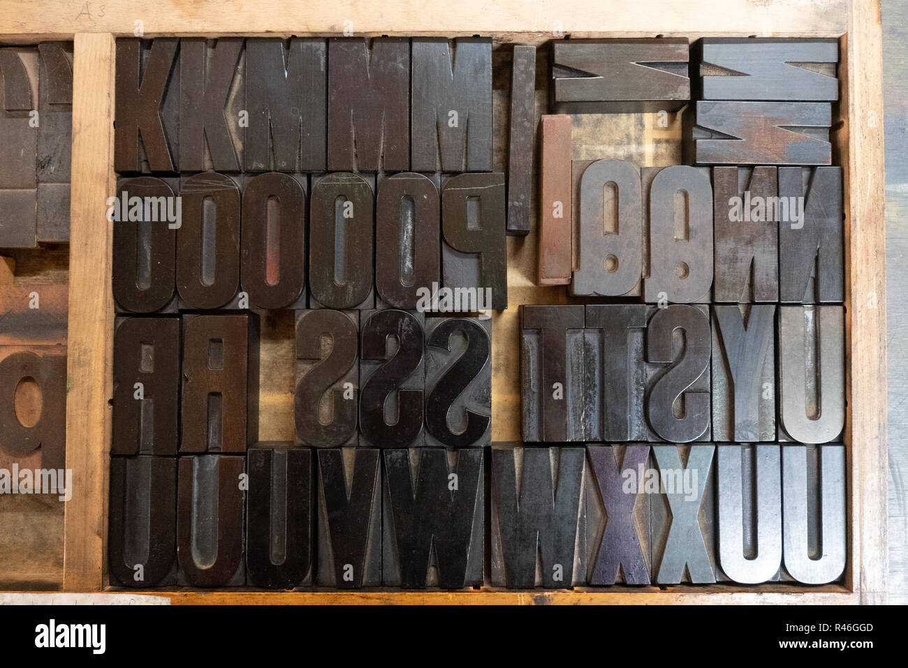 Jumble of different metal letters in a tray for use in an old ...