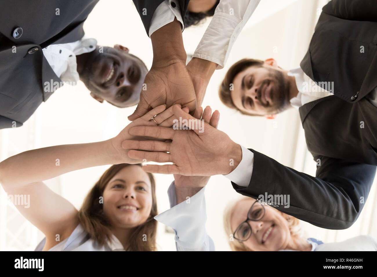 Diverse business team put hands together as concept of teambuild Stock ...