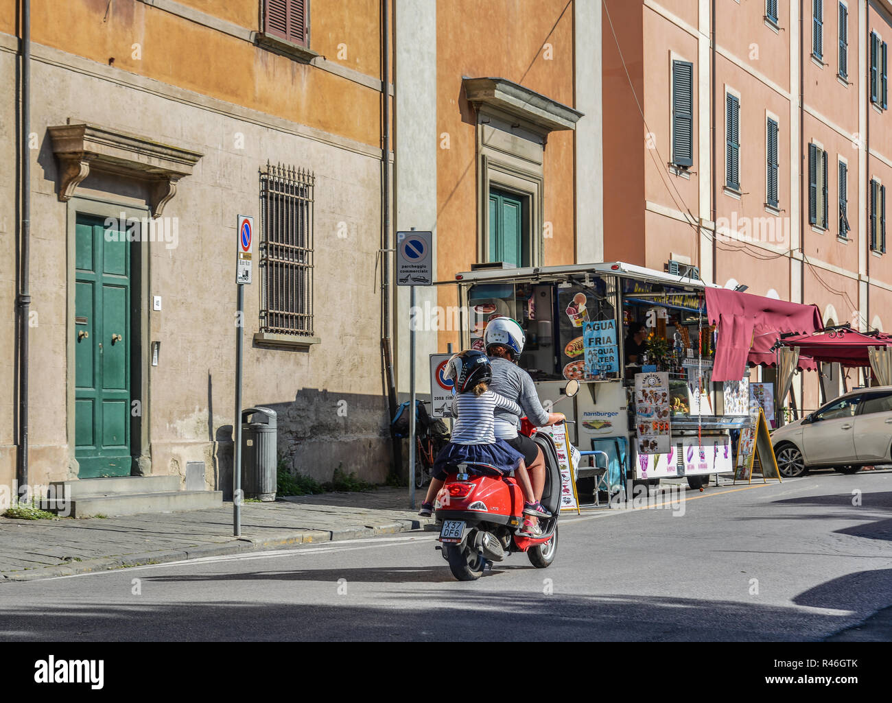 Pisa, Italy - Oct 18, 2018. People riding Vespa on street in Pisa ...
