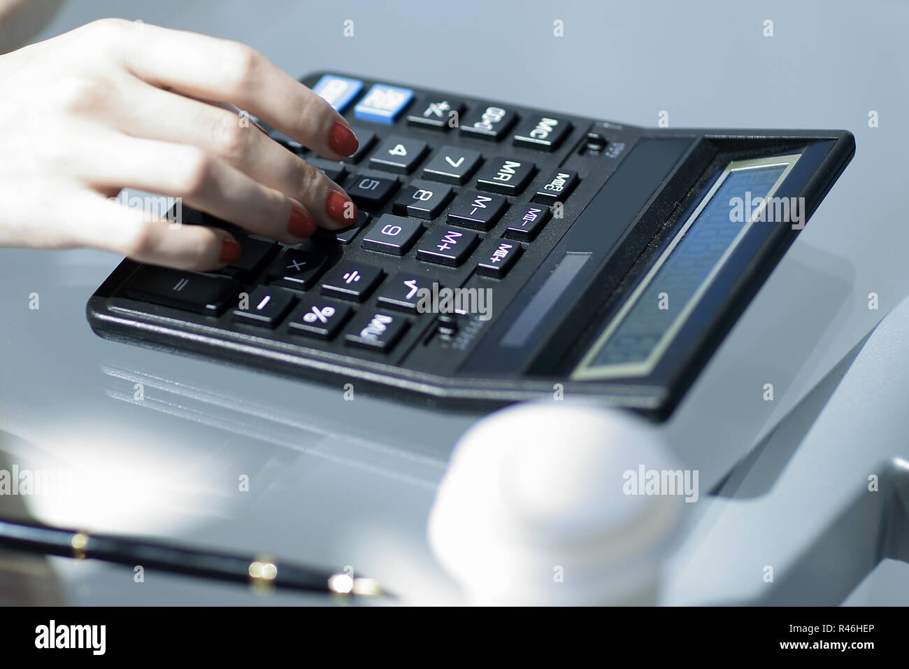 .closeup.business woman using a calculator at the workplace Stock Photo ...