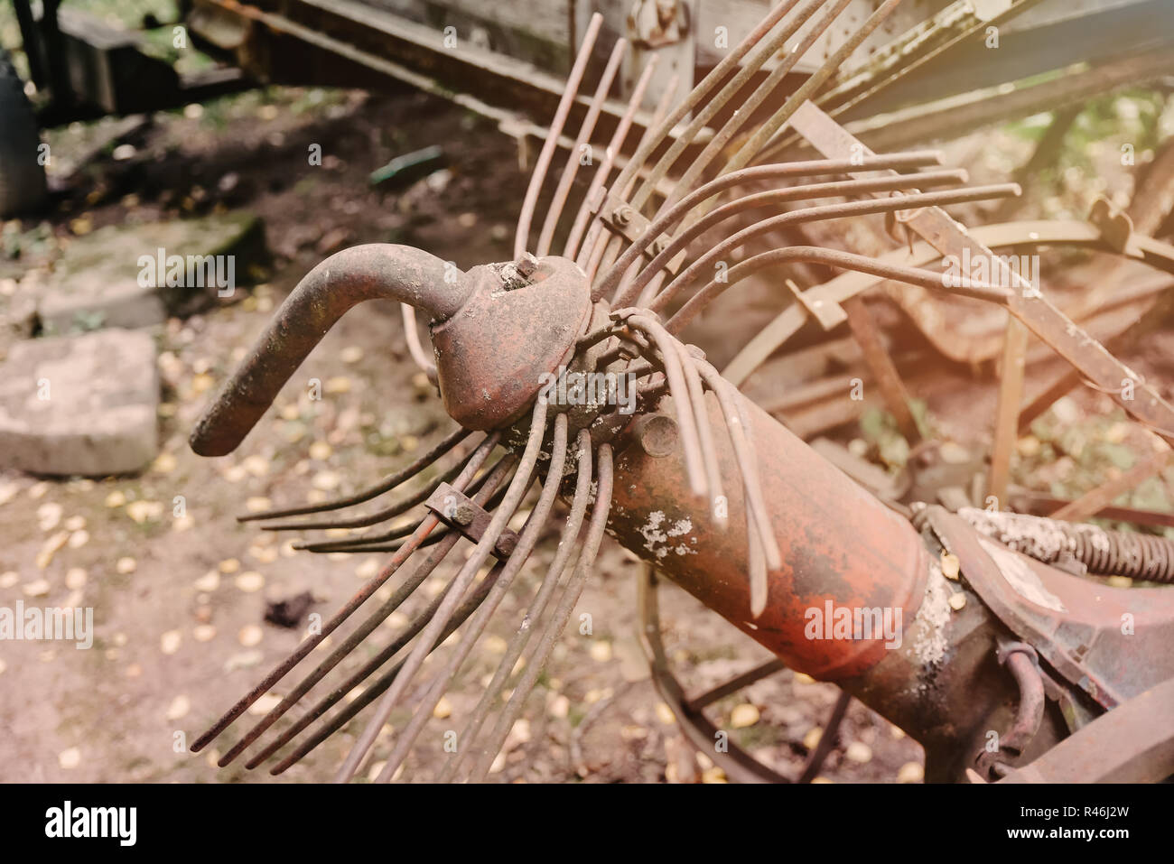 abandoned rusty old farm machinery in garden Stock Photo - Alamy