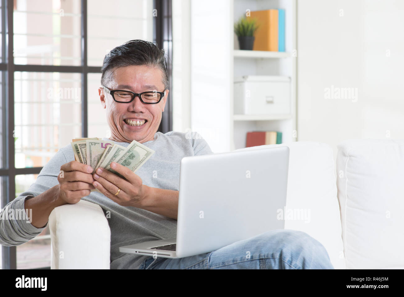 Mature adult businessman counting money hi-res stock photography and ...