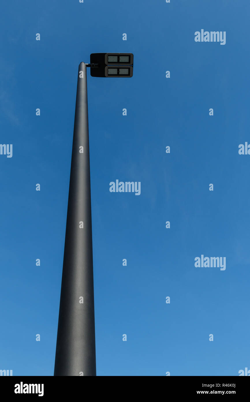 Modern LED street lamp post against a blue sky Stock Photo - Alamy