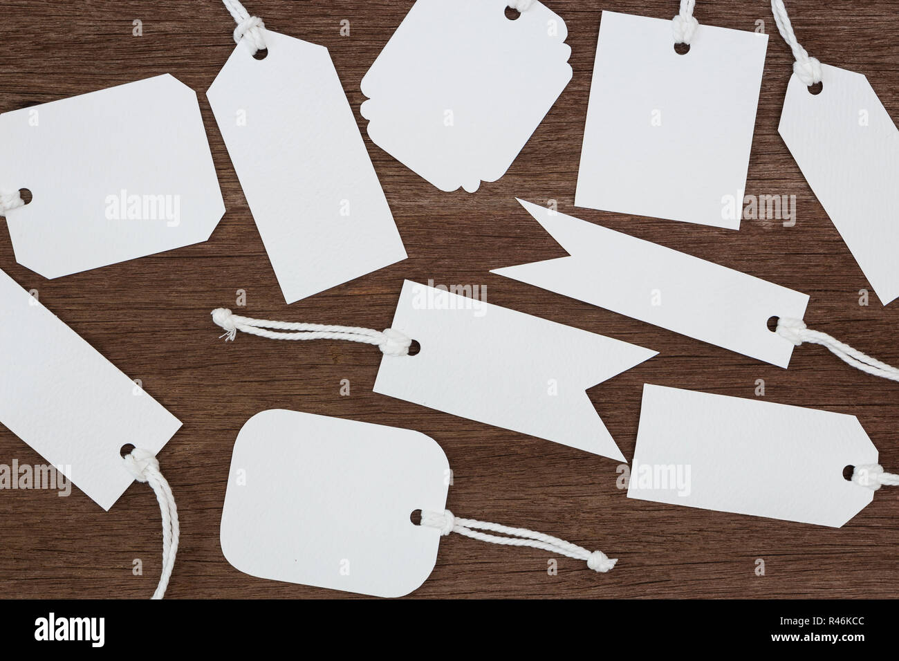 blank white paper tags label on wood background Stock Photo - Alamy