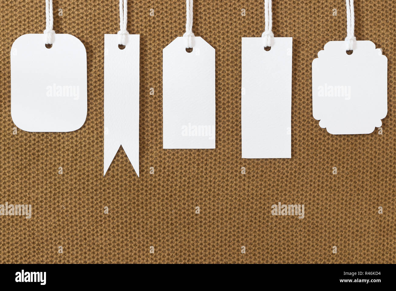 white blank tags label on fabric texture Stock Photo - Alamy