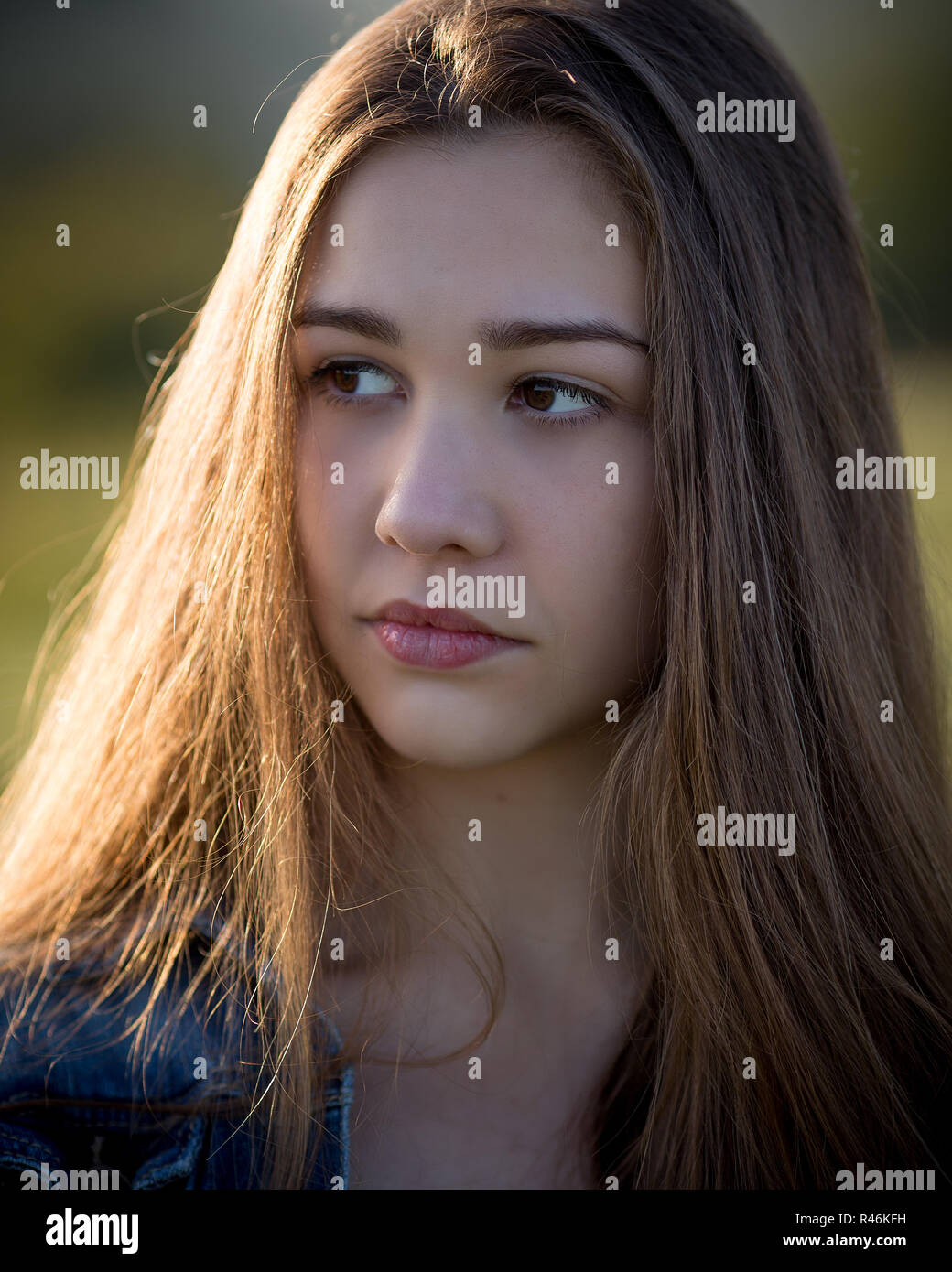 Beautiful Young Woman With Long Hair Outside In The Sun Stock Photo - Alamy