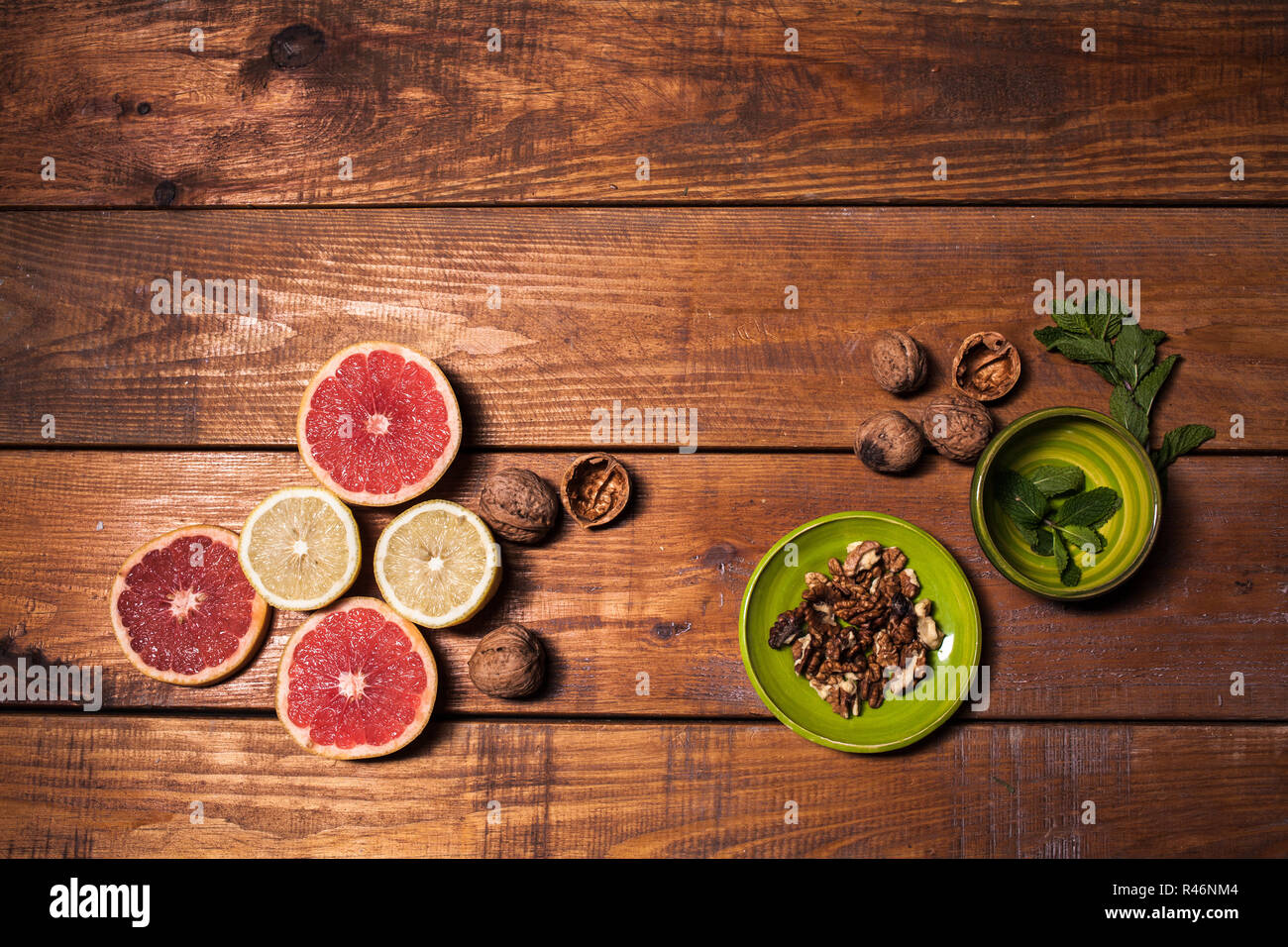 Lemon and walnut on a wooden surface close up Stock Photo - Alamy