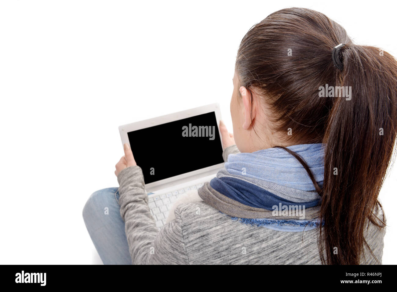 back view of beautiful business woman holding laptop with empty screen ...