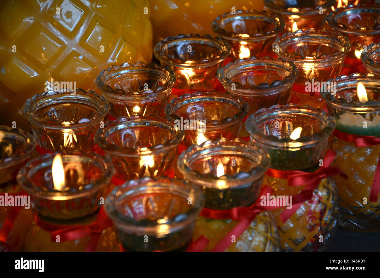 Temple candles in transparent chandeliers Stock Photo - Alamy