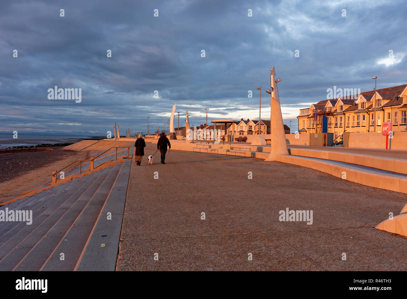Cleveleys split promenade and coastal flood defences with two people ...