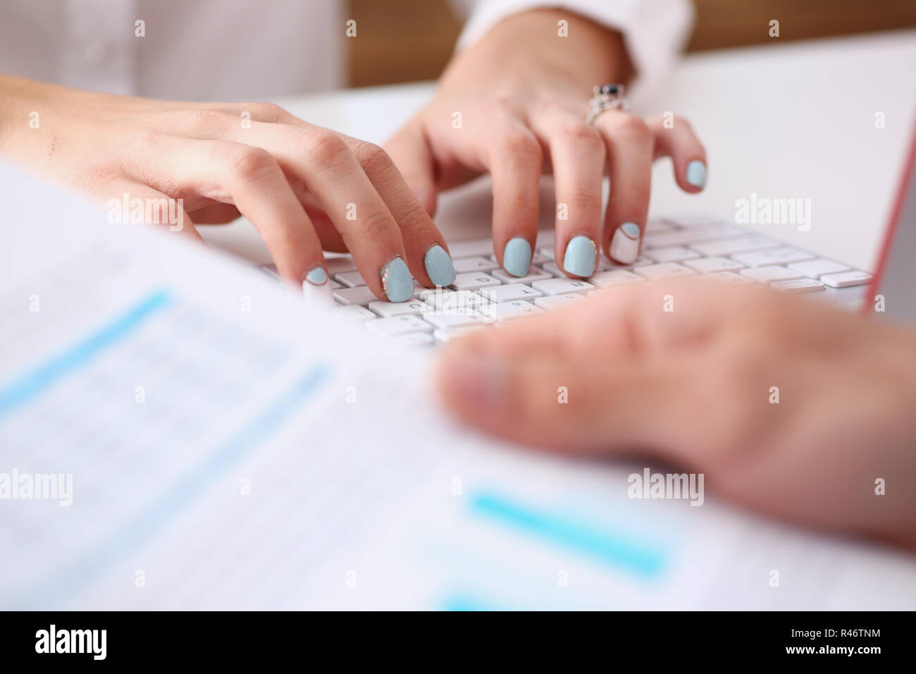 Female hands typing on silver keyboard using computer Stock Photo - Alamy