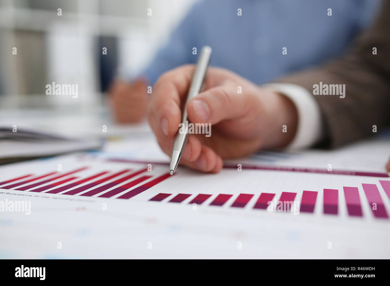 Group of people deliberate on problem with infographics Stock Photo - Alamy