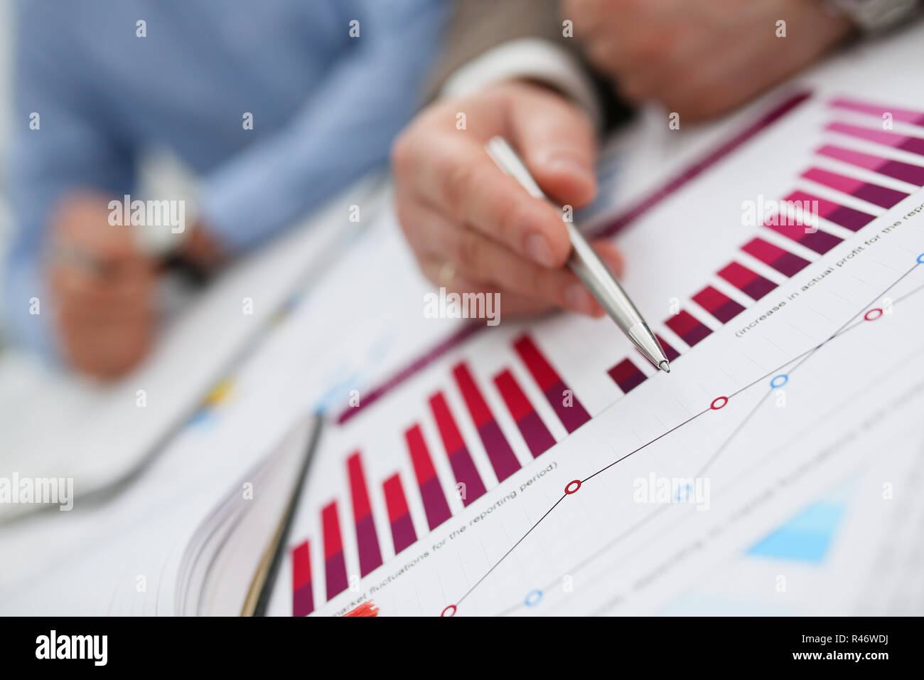 Group of people deliberate on problem with infographics Stock Photo - Alamy