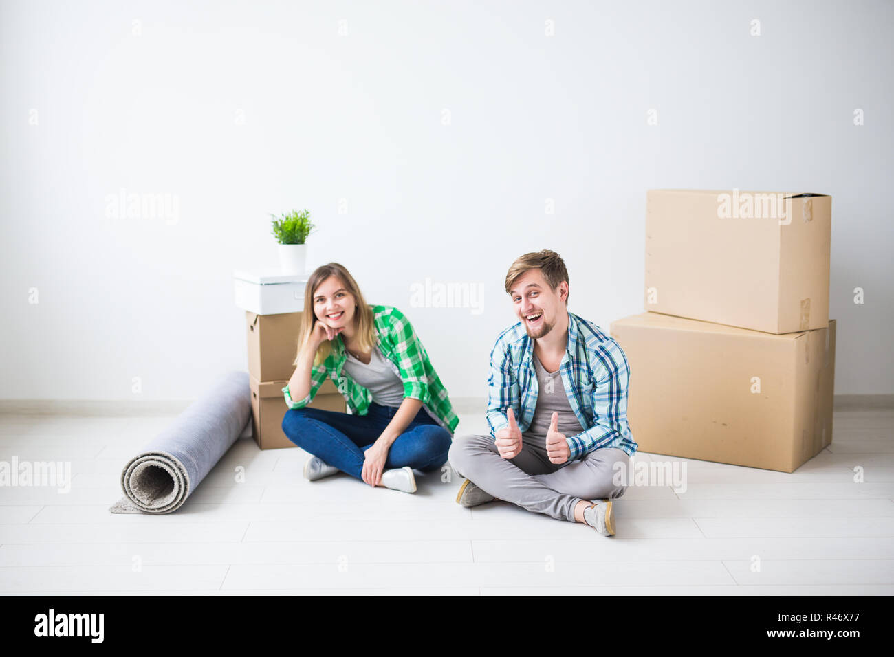 Relocation, real estate and moving concept - young couple people moved ...