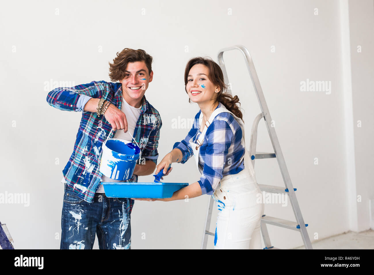 People, repair and renovation concept - Beautiful woman and handsome ...