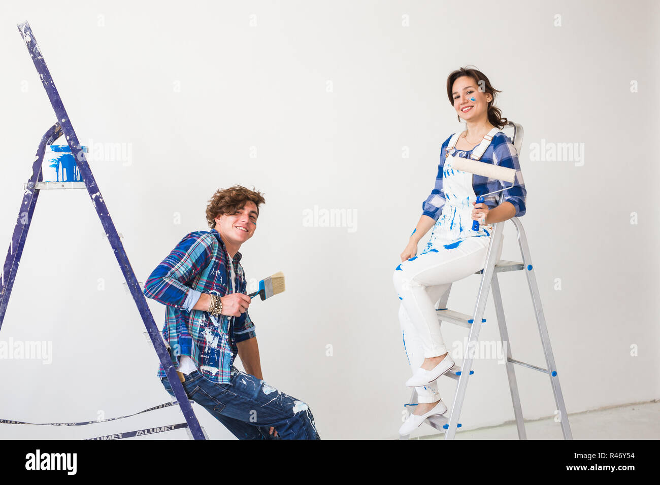 Teamwork, renovation and repair concept - Man and woman covered in ...