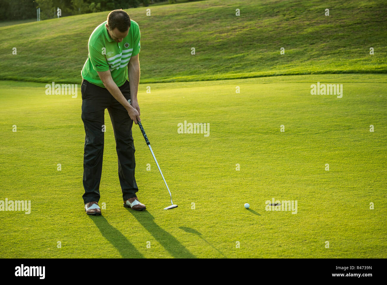 golfers on the golf course Stock Photo - Alamy