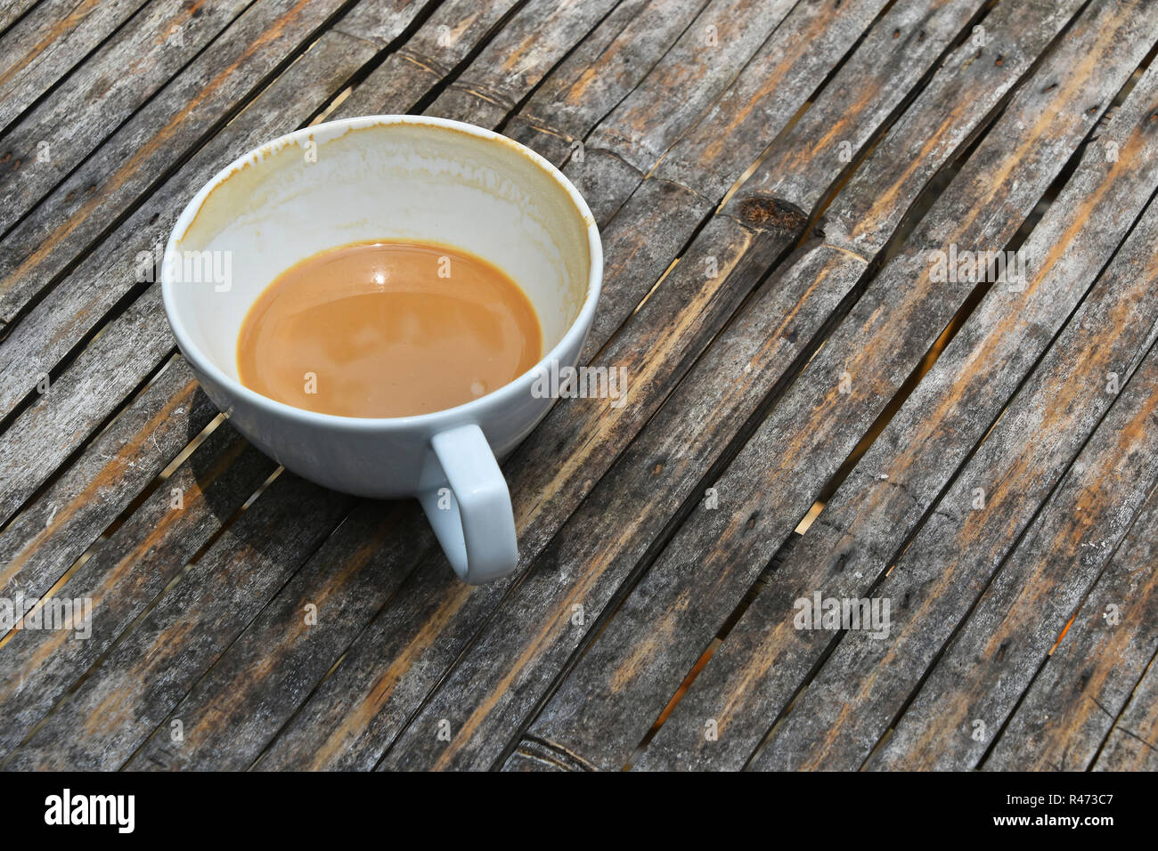 One finished cup of latte coffee on bamboo table Stock Photo - Alamy