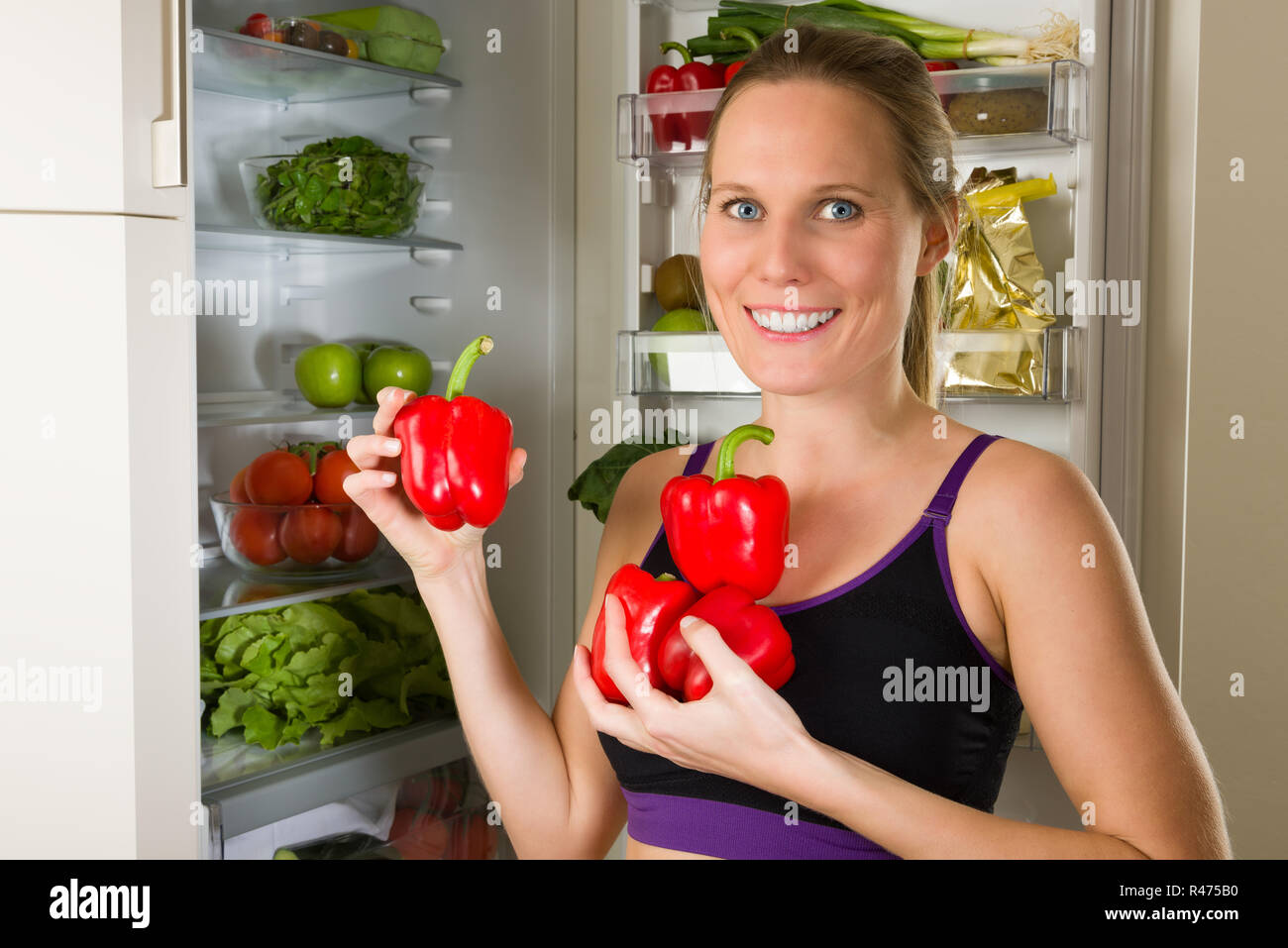 Sporty, Caucasian woman showing vegetables for healthy eating Stock ...