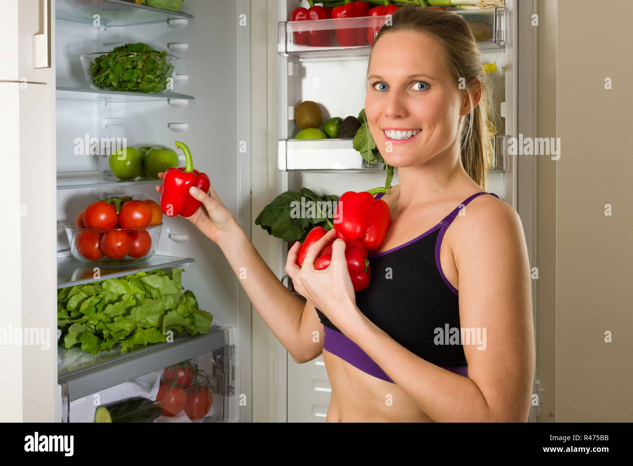 Sporty, Caucasian woman showing vegetables for healthy eating Stock ...