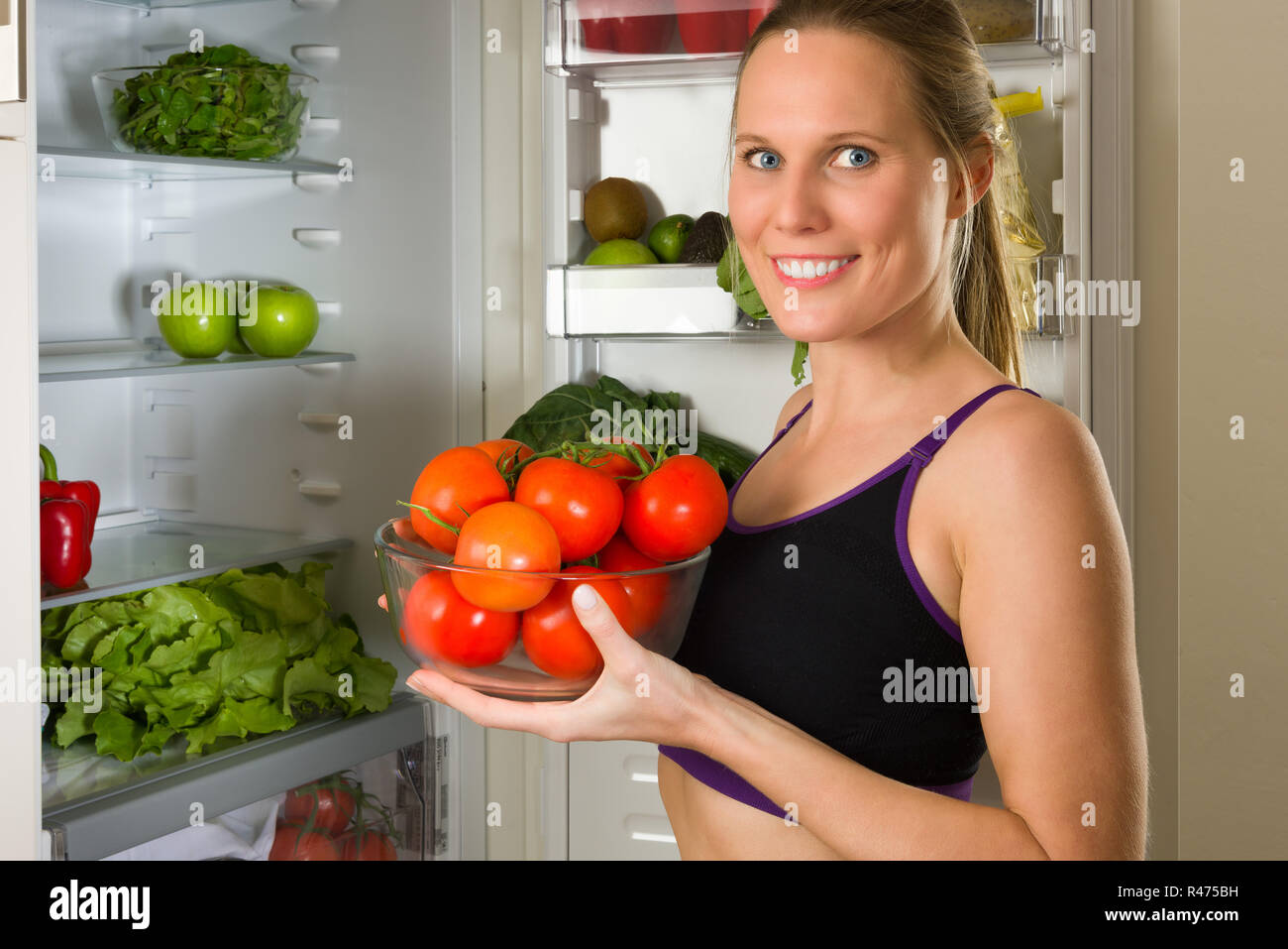 Sporty, Caucasian woman showing vegetables for healthy eating Stock ...