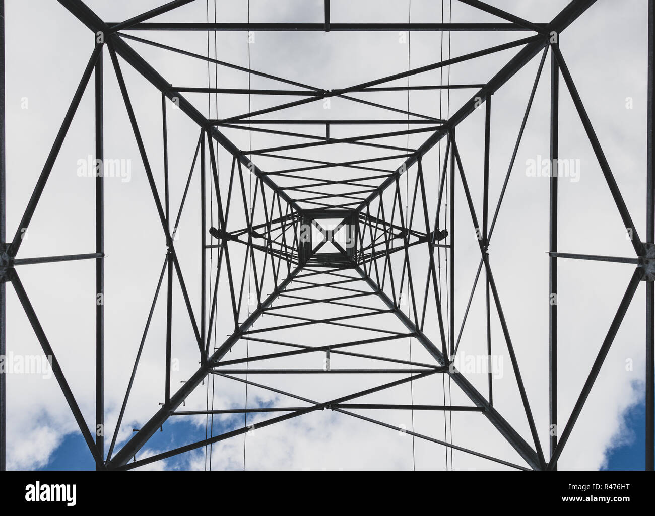 Steel electricity transmission line power tower abstract with clouds ...