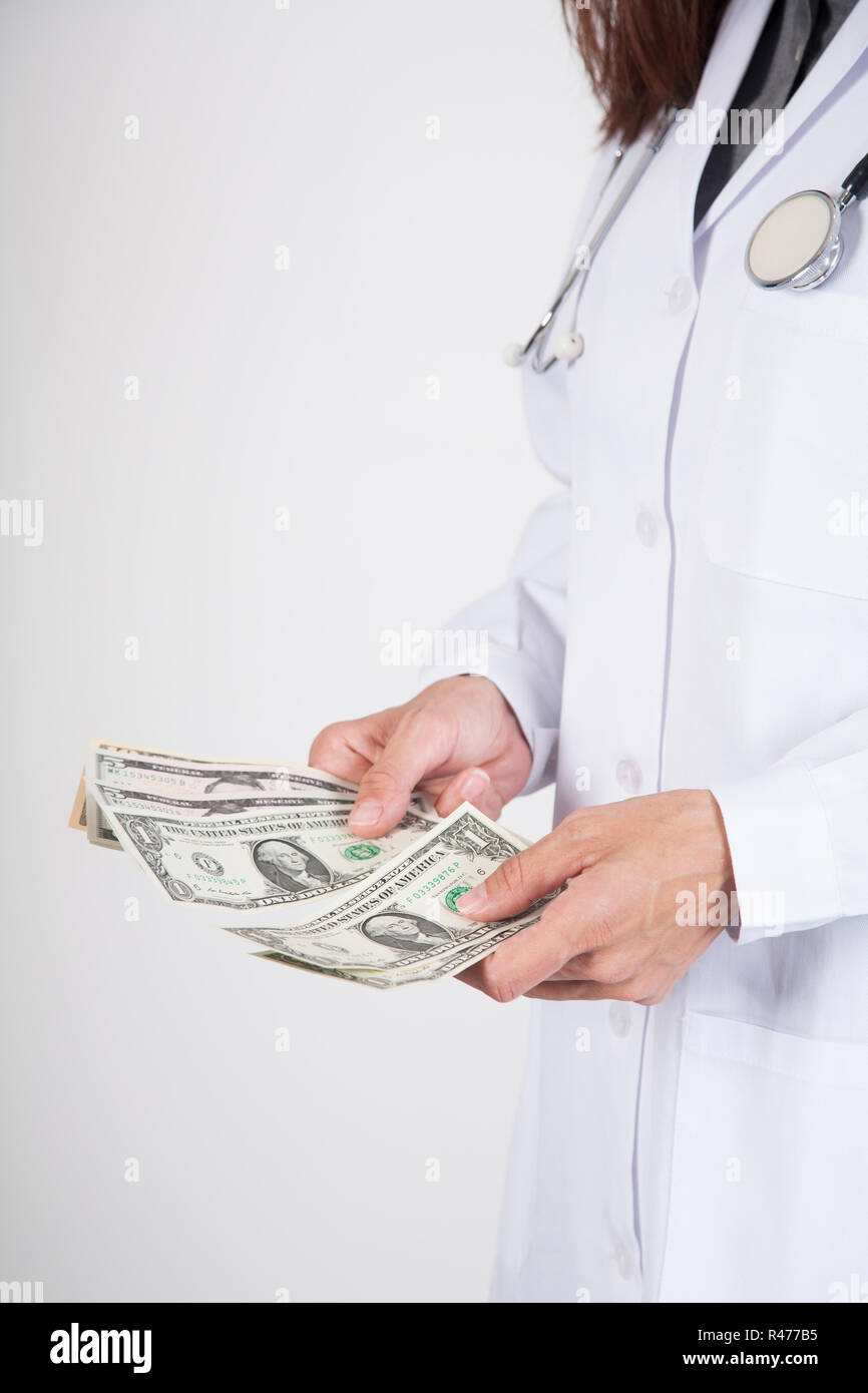 doctor counting dollar banknotes Stock Photo - Alamy