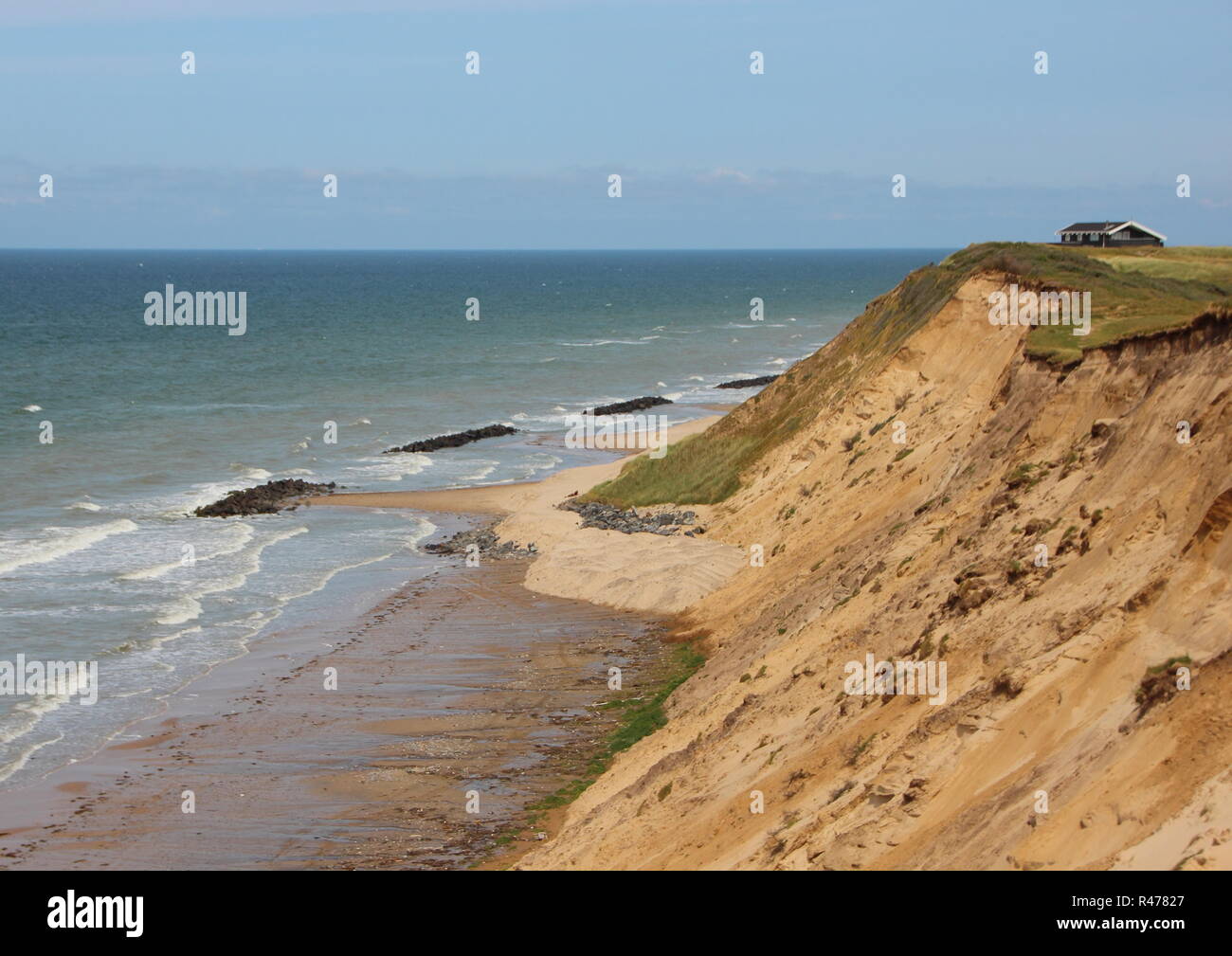 Sandy Cliff Landscape at Ocean and House near Edge Stock Photo - Alamy