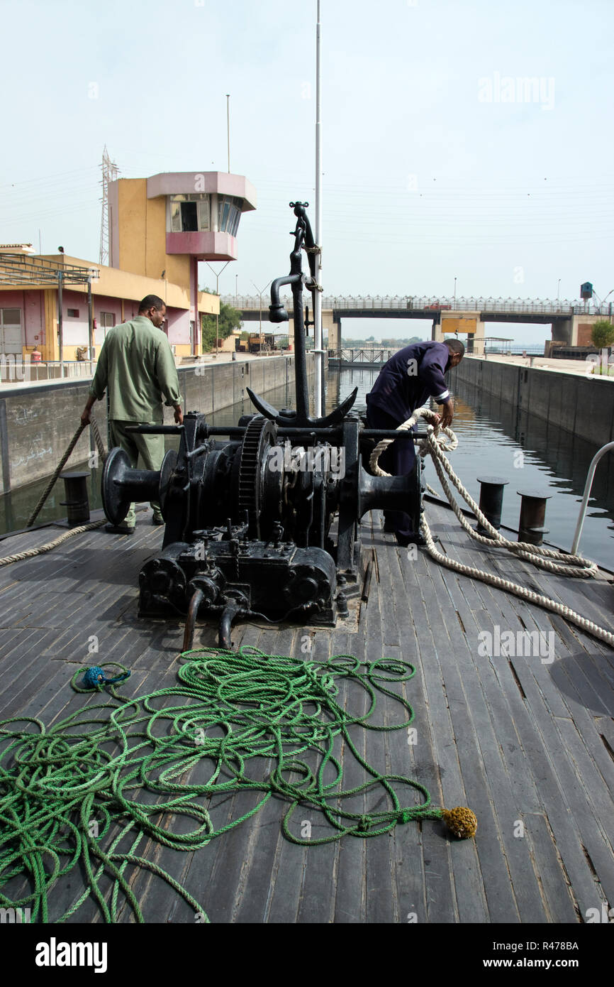 Deck crew on the historic MS Sudan steamship prepare ropes to guide it ...