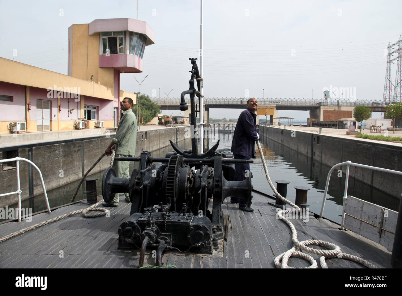 Deck crew on the historic MS Sudan steamship prepare ropes to guide it ...