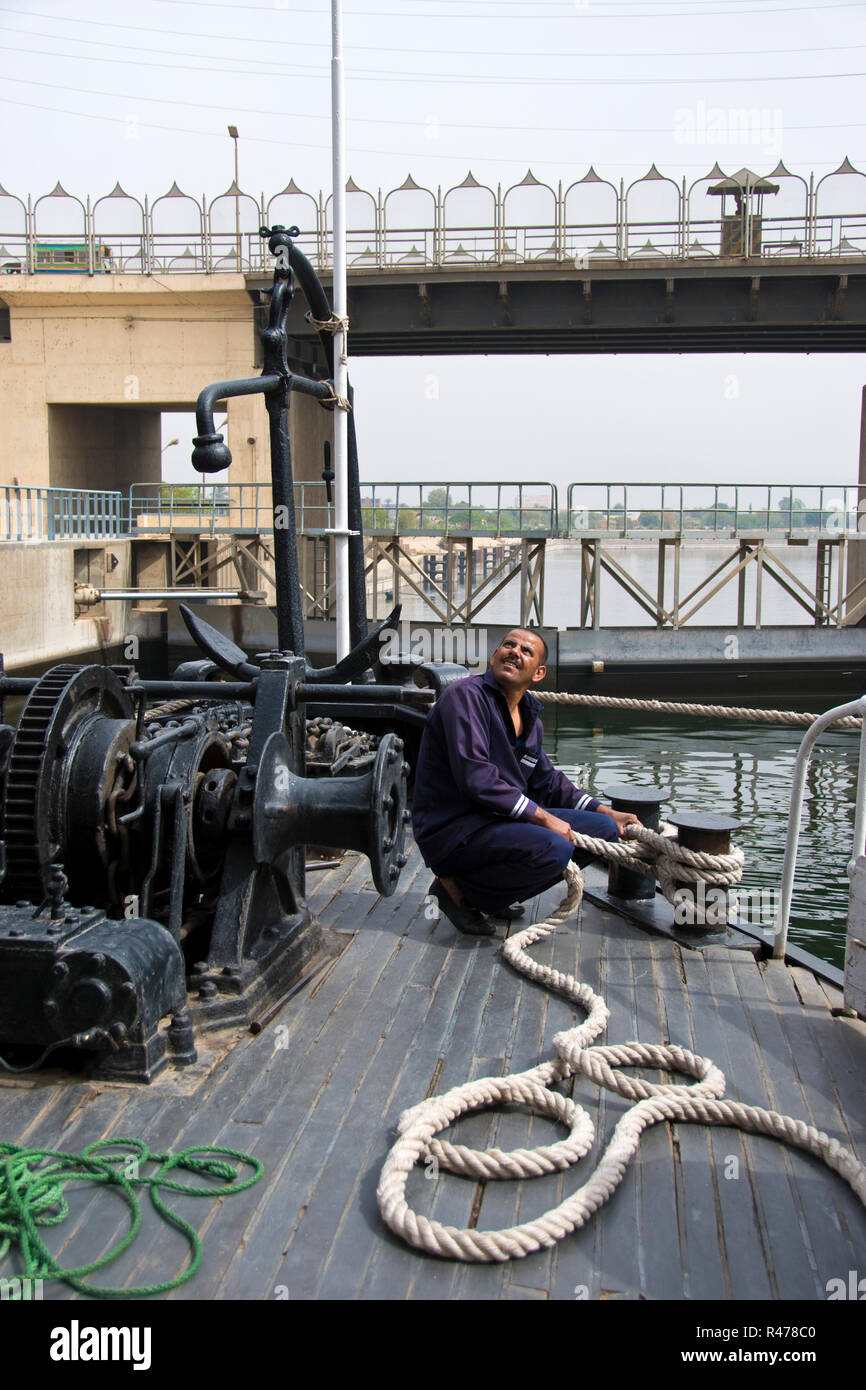 Deck crew on the historic MS Sudan steamship prepare ropes to guide it ...