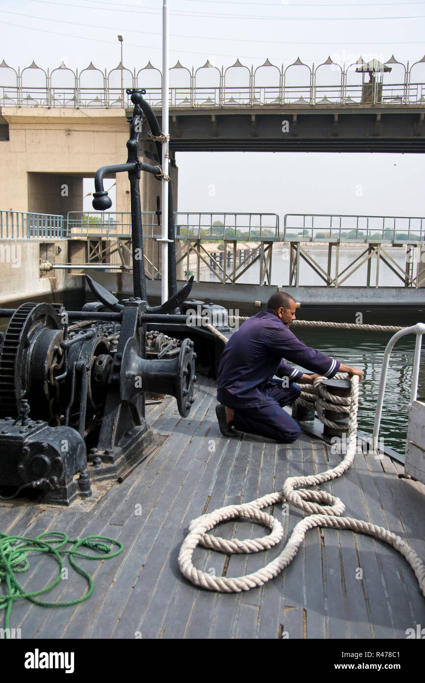 Deck crew on the historic MS Sudan steamship prepare ropes to guide it ...