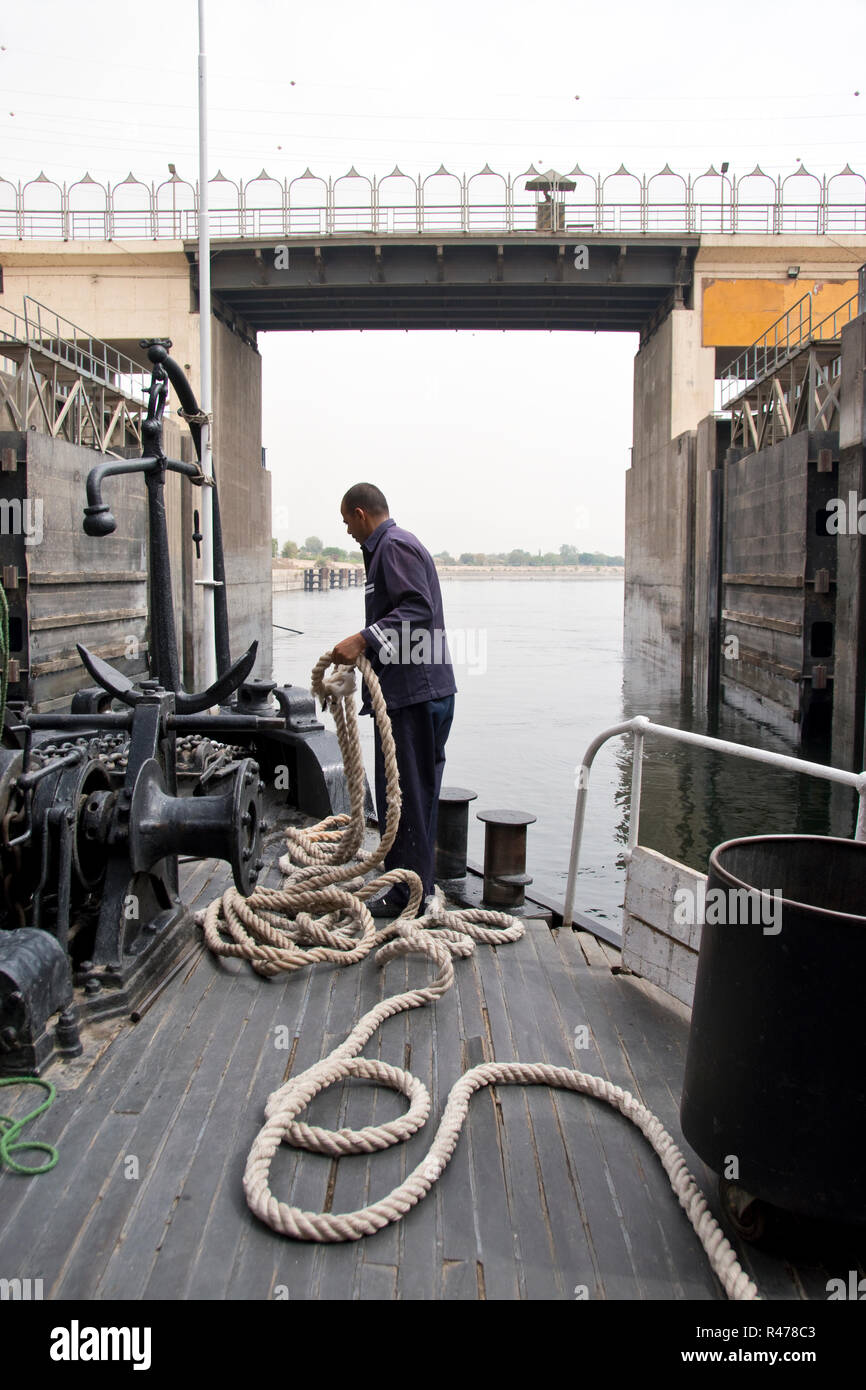 Deck crew on the historic MS Sudan steamship prepare ropes to guide it ...