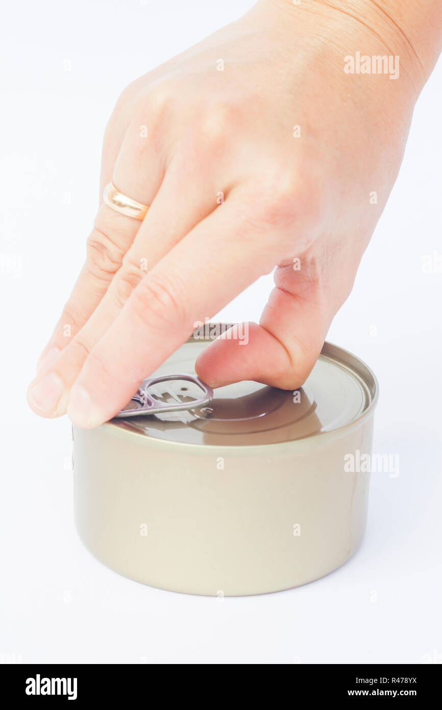 Close-up tin can with hand isolated on white background Stock Photo - Alamy